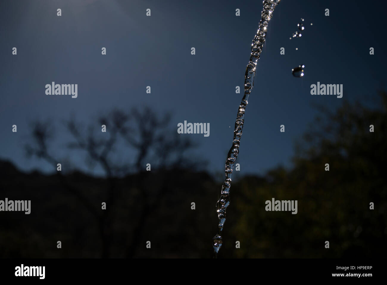 Falling water jet with background of green mountain, sky and tree Stock ...