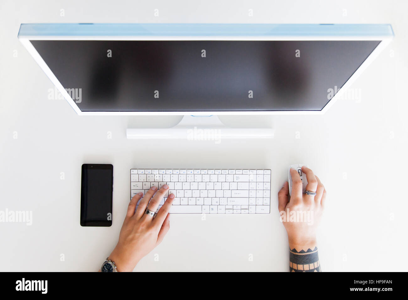 Man hand on desktop keyboard with blank screen monitor. White ...