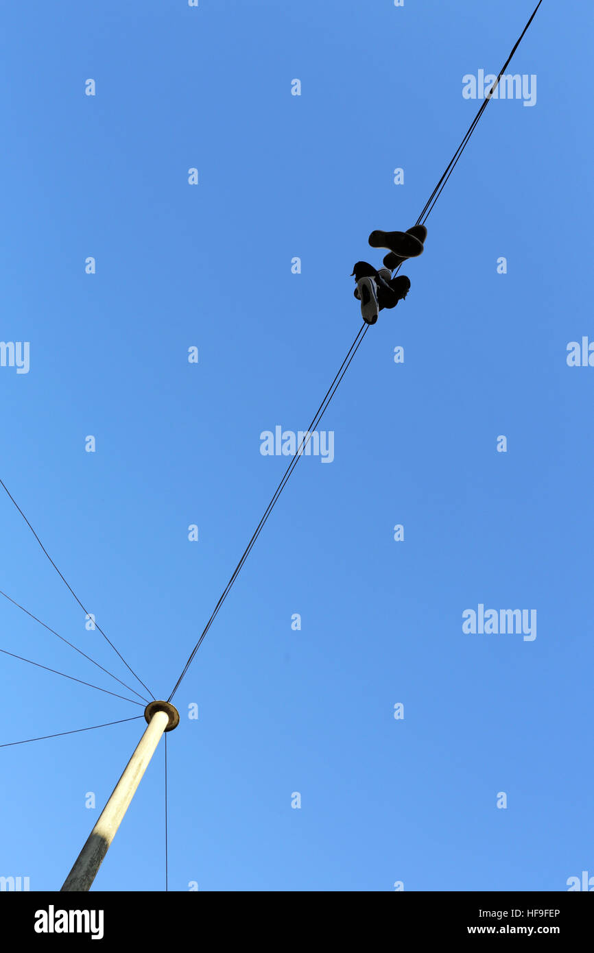Shoes Hanging on power lines Stock Photo - Alamy