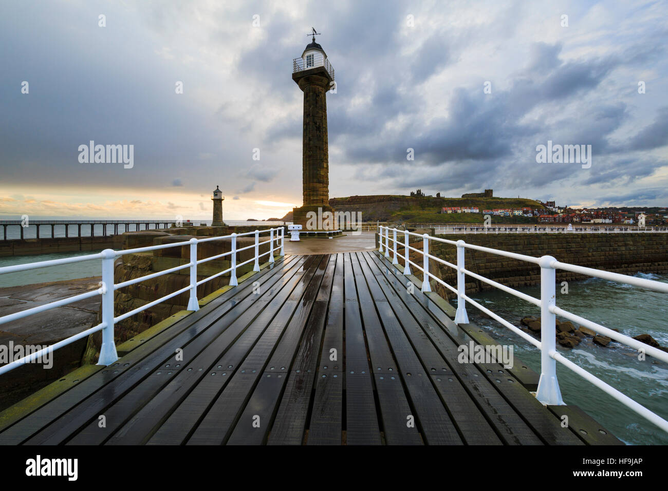 Whitby lighthouse and pier at sunrise. North Yorkshire, UK Stock Photo ...