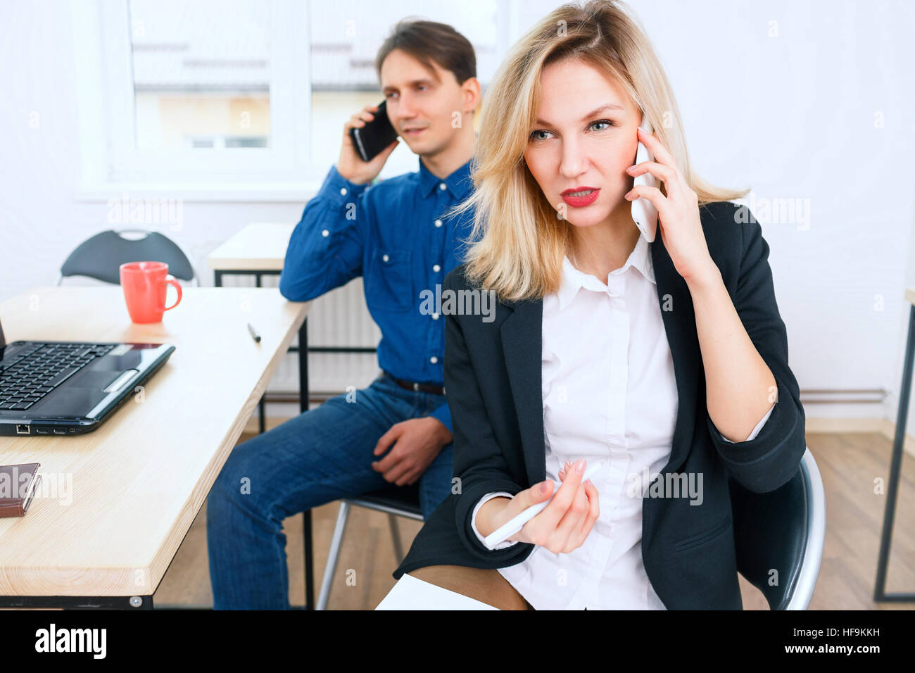 Office managers having a phone conversation Stock Photo - Alamy