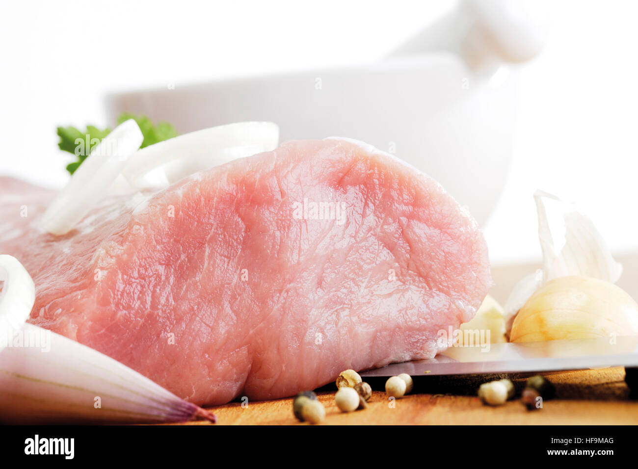 Raw pork filet, onions and peppercorns Stock Photo - Alamy