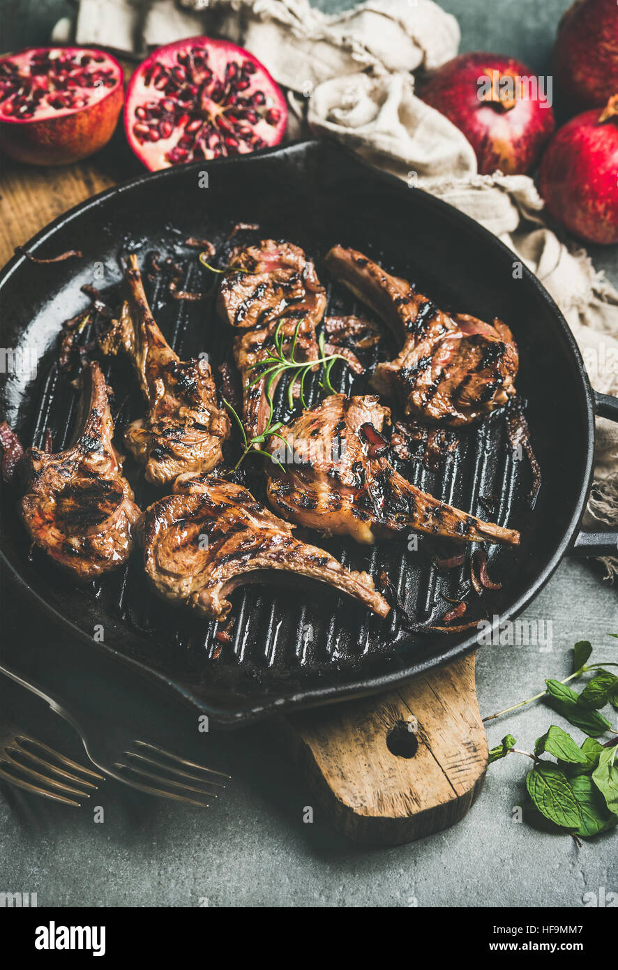 Grilled lamb meat chops served with fresh pomegranates and mint Stock ...