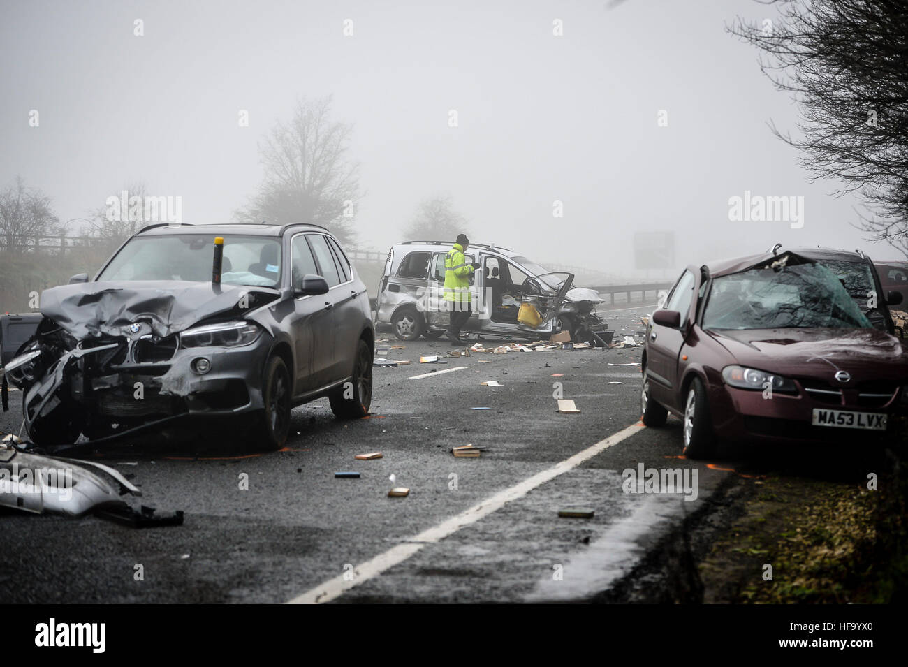 A Thames Valley Police collision investigator takes notes by damaged ...