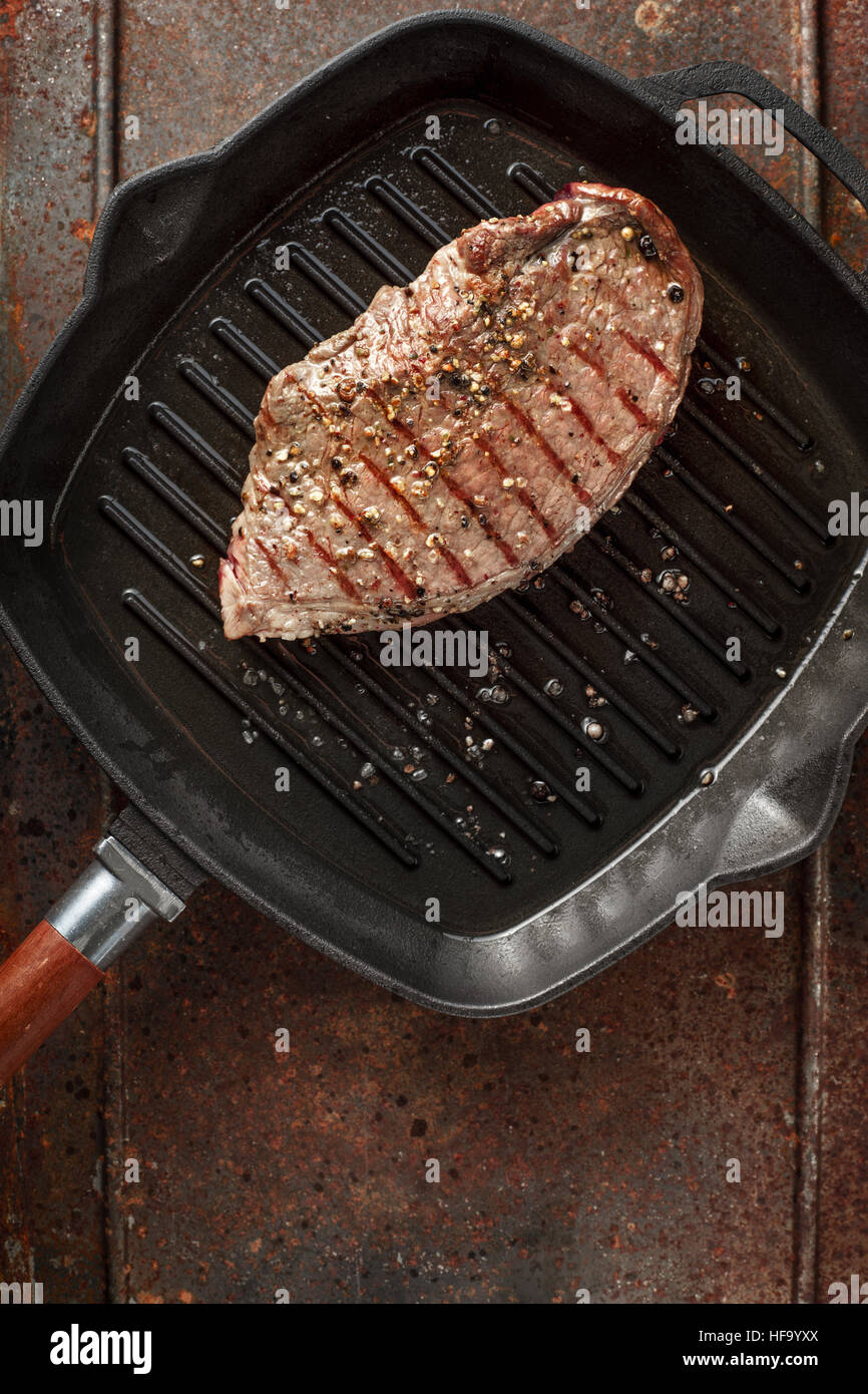 Roast beef steak on pan grill vertical Stock Photo - Alamy