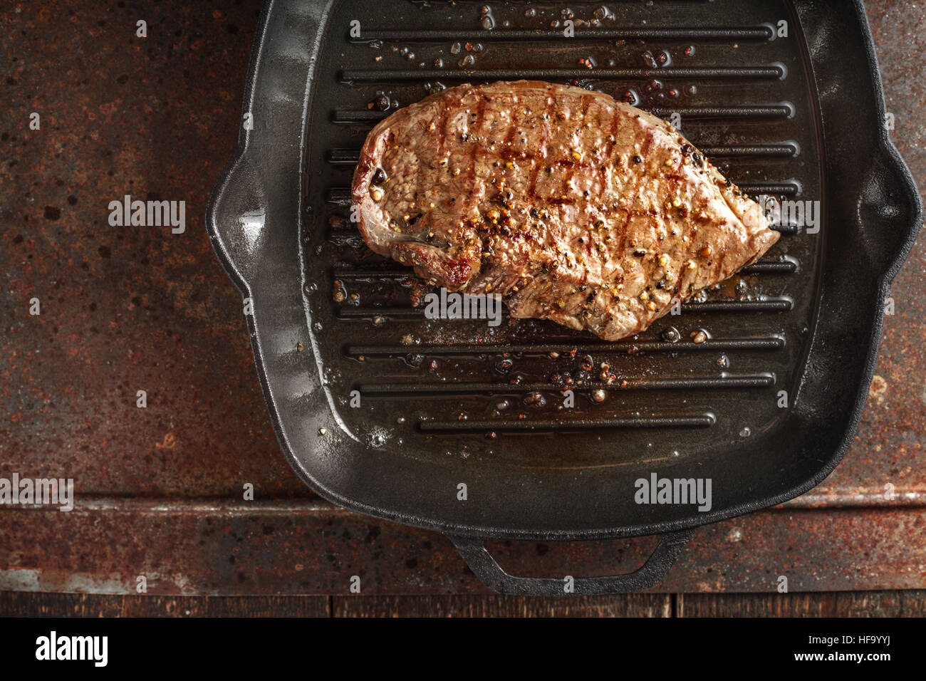 Roast beef steak in spices on pan grill horizontal Stock Photo - Alamy