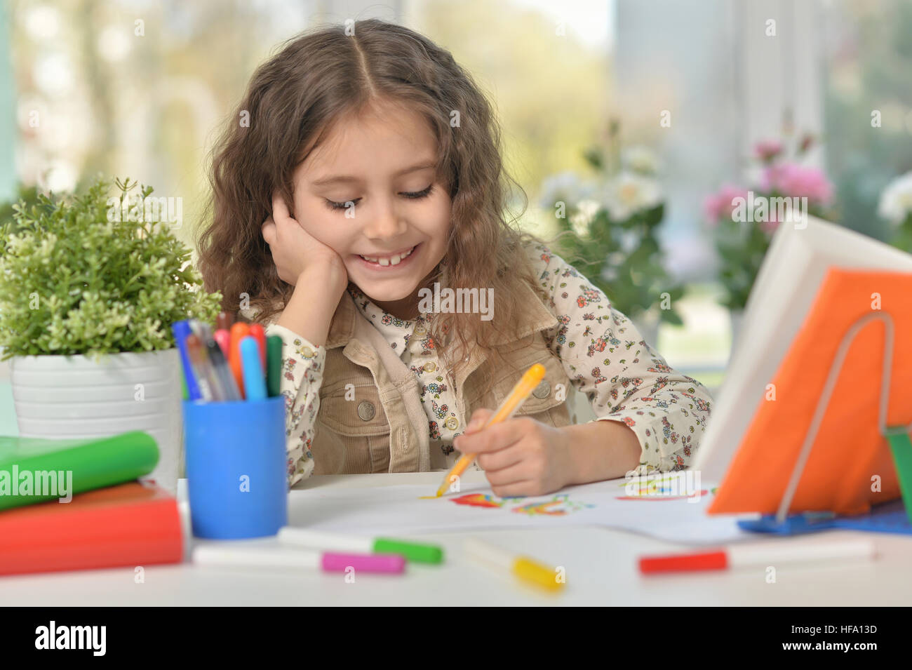 Little girl drawing at class Stock Photo - Alamy