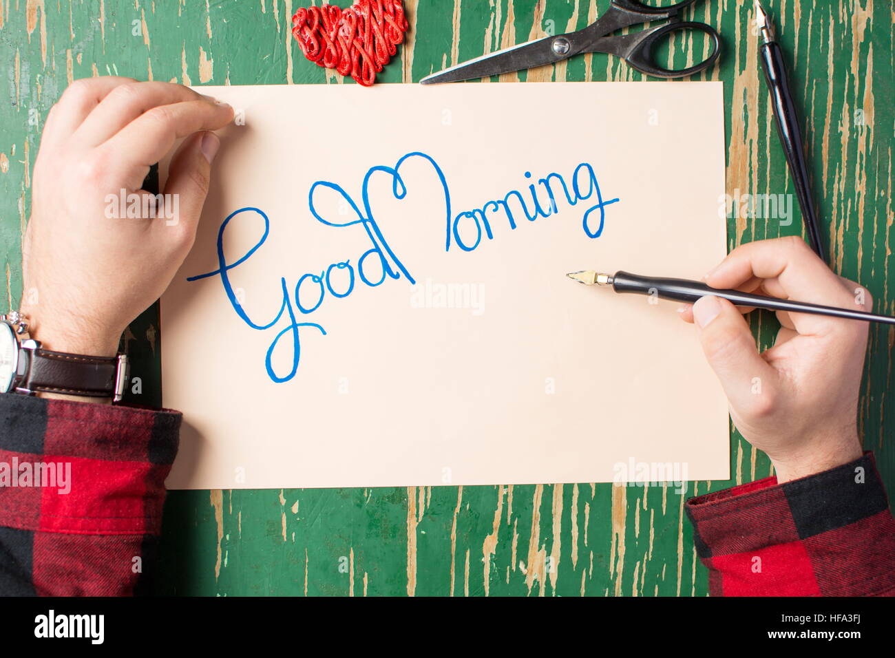 Man writing a good morning note top view Stock Photo - Alamy