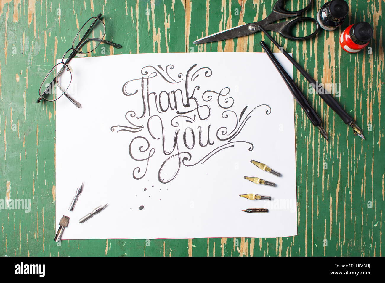 Thank you note calligraphy with writing equipment on the table Stock ...