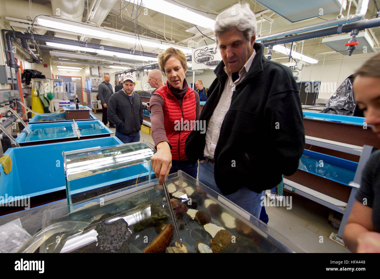 A biologist reaches into a tank of marine wildlife as she speaks with U ...