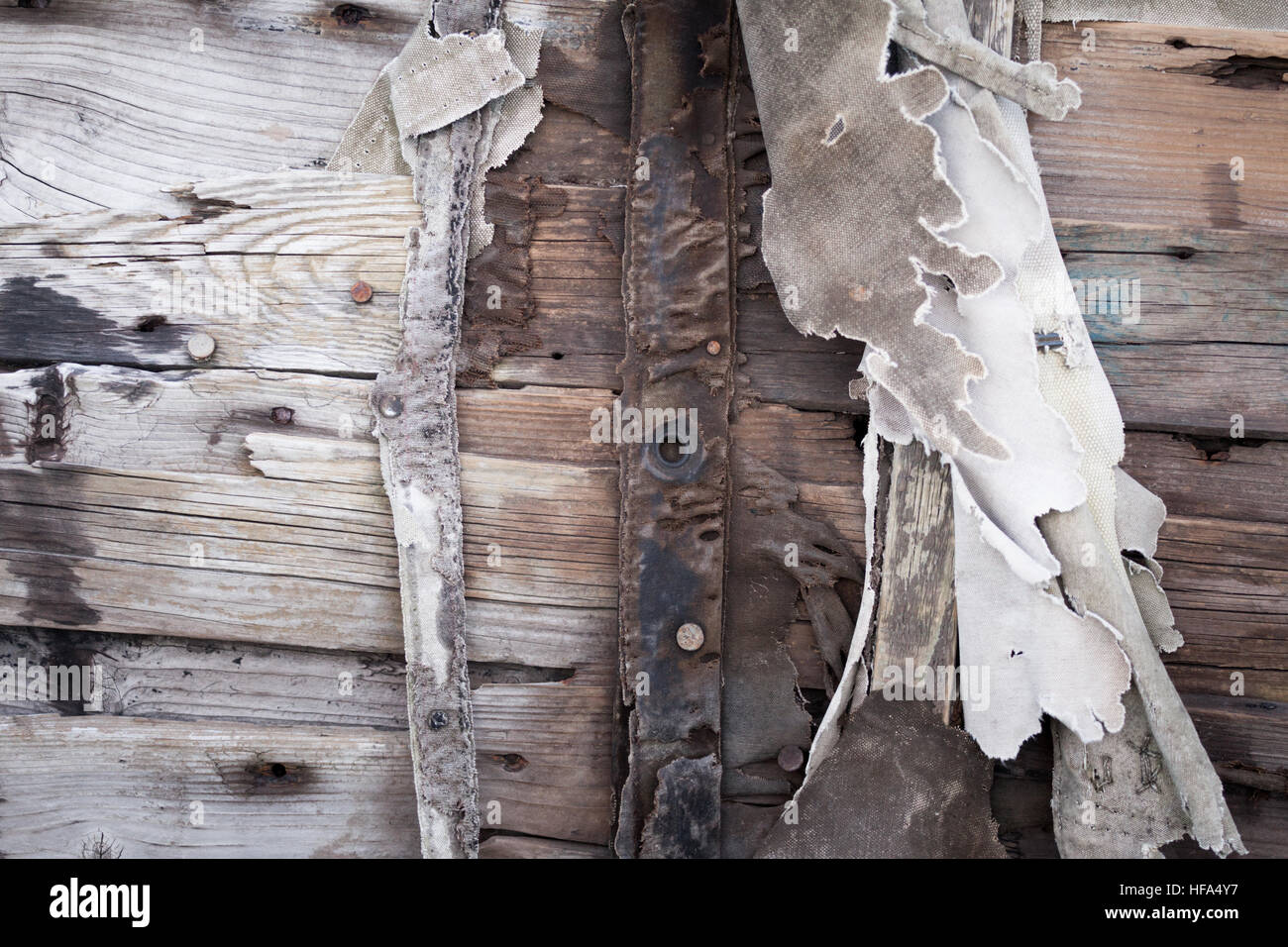 Old fabric tarpaulin worn by the weather on a wooden fishing boat at ...