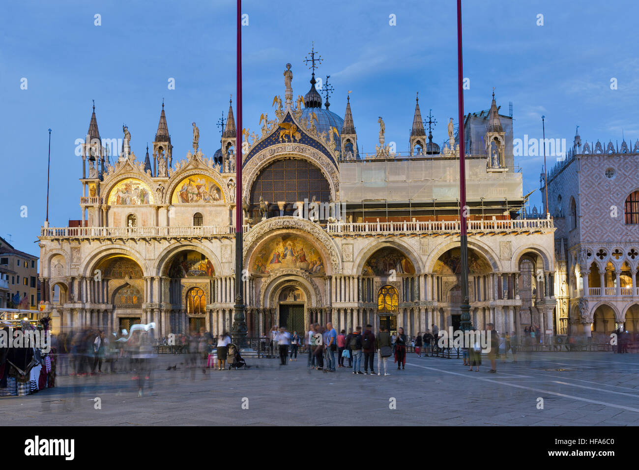 Unrecognized people walk along San Marko cathedral at night in Venice ...