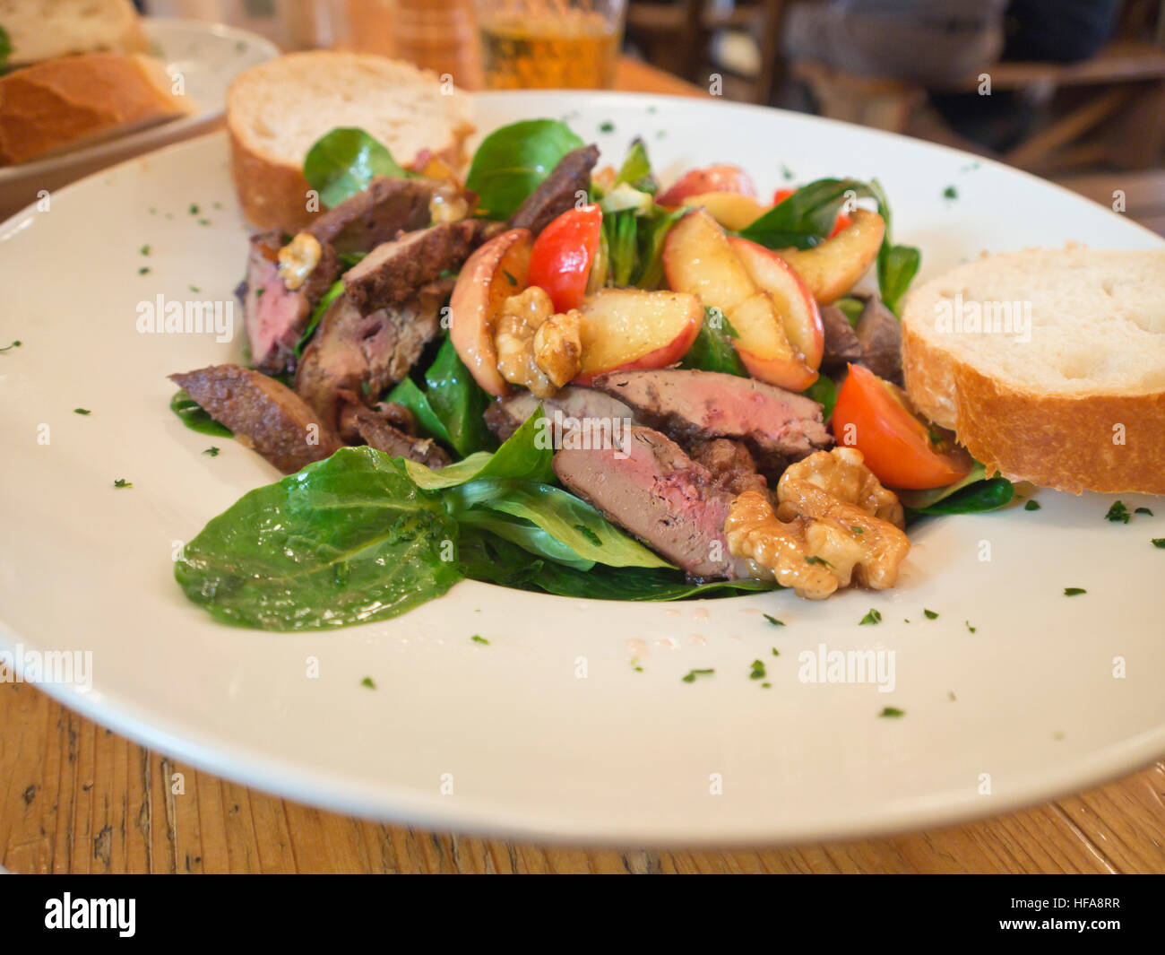 Goose liver salad with apples and walnuts delicious lunch dish in a ...
