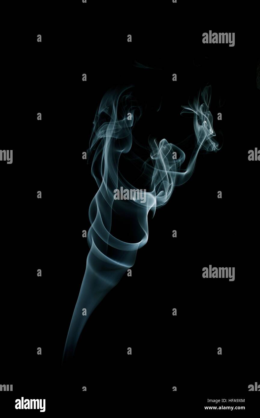 Smoke rising up isolated on a black background Stock Photo - Alamy