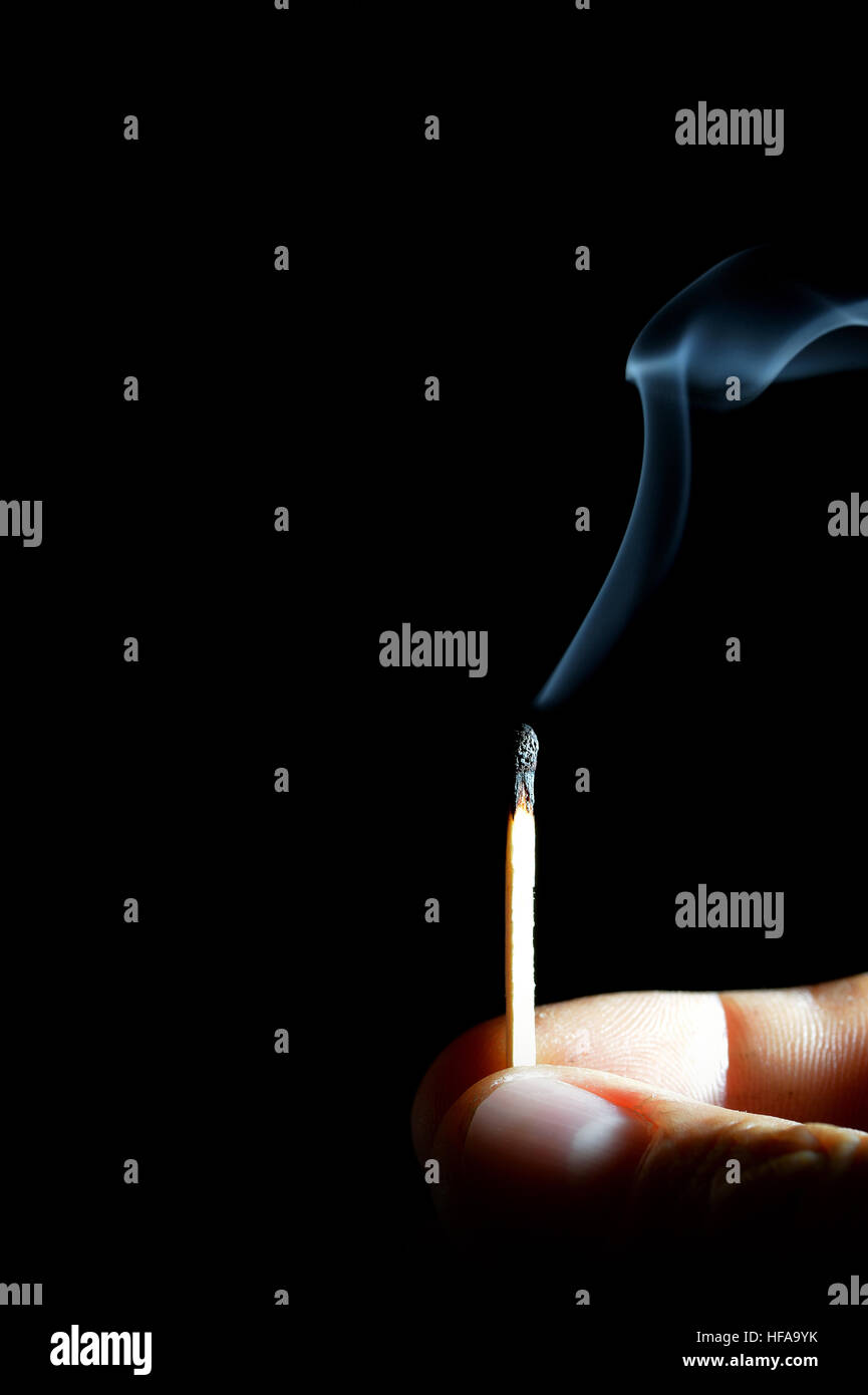 Hand holding matchstick with smoke trail Stock Photo - Alamy