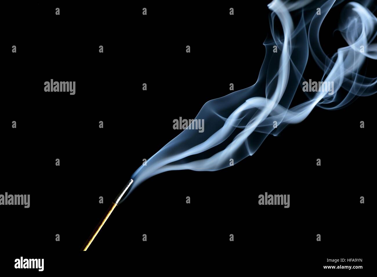 Incense stick with smoke on black background Stock Photo - Alamy