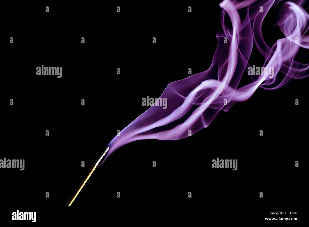 Incense stick with smoke on black background Stock Photo - Alamy