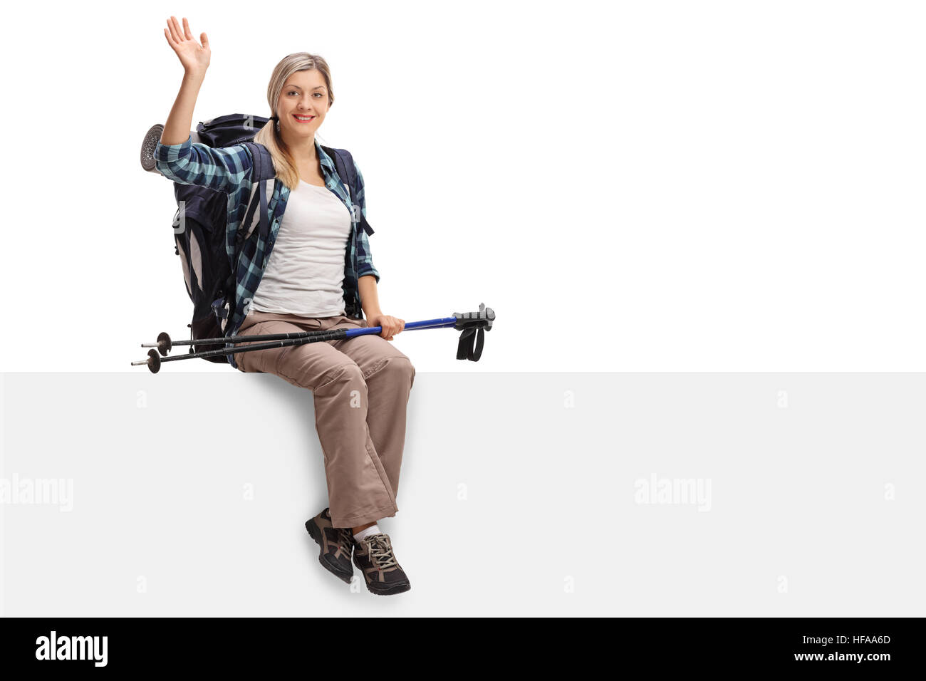 Happy female hiker sitting on a panel and waving isolated on white ...