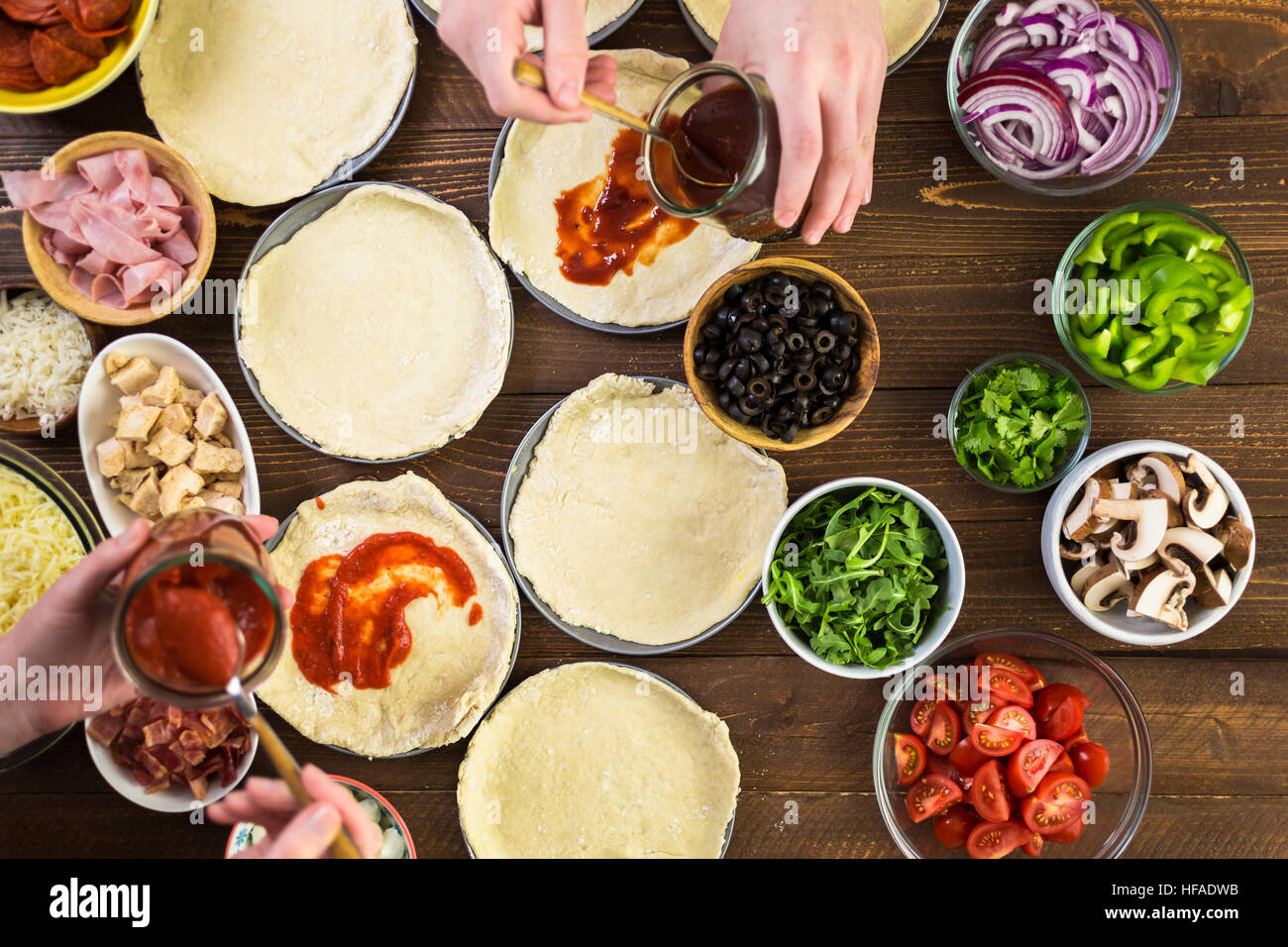 Preparing individual pizzas from pizza bar Stock Photo - Alamy