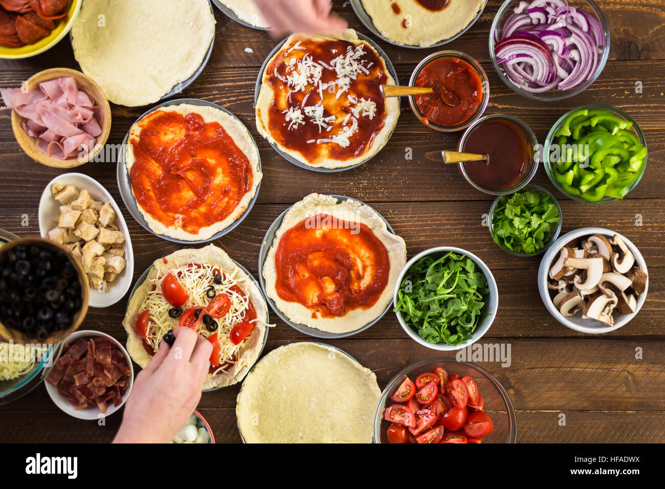 Preparing individual pizzas from pizza bar Stock Photo - Alamy