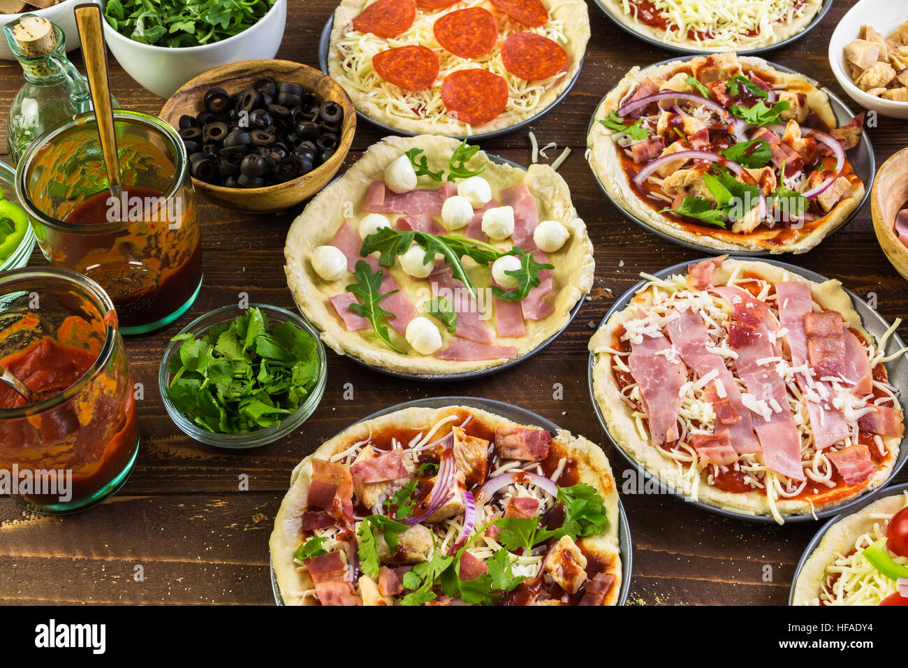 Preparing individual pizzas from pizza bar Stock Photo - Alamy