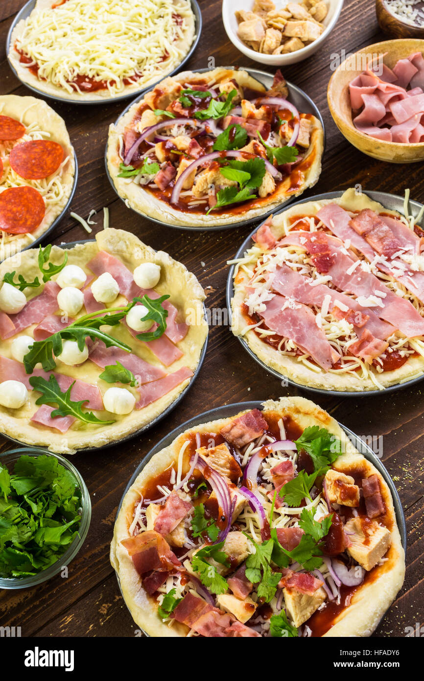 Preparing individual pizzas from pizza bar Stock Photo - Alamy