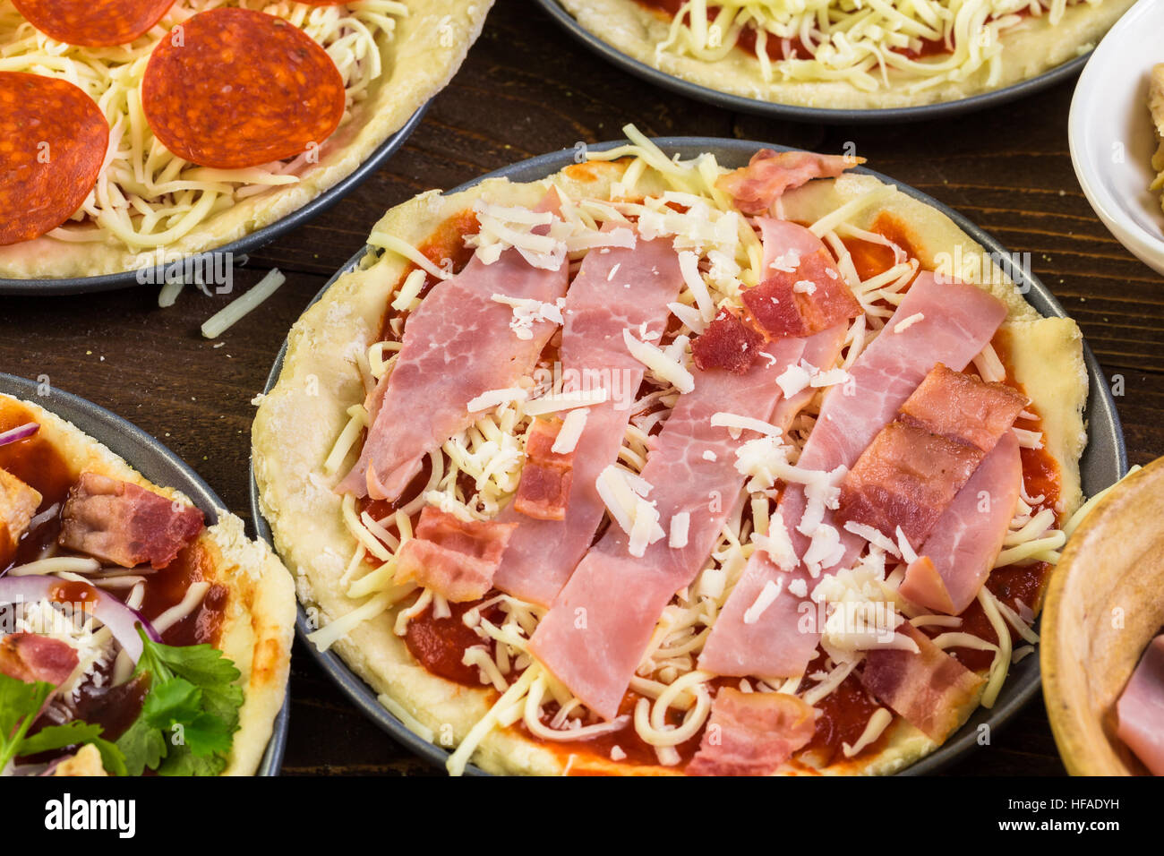 Preparing individual pizzas from pizza bar Stock Photo - Alamy
