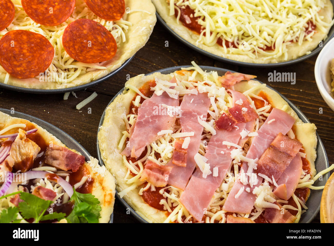 Preparing individual pizzas from pizza bar Stock Photo - Alamy
