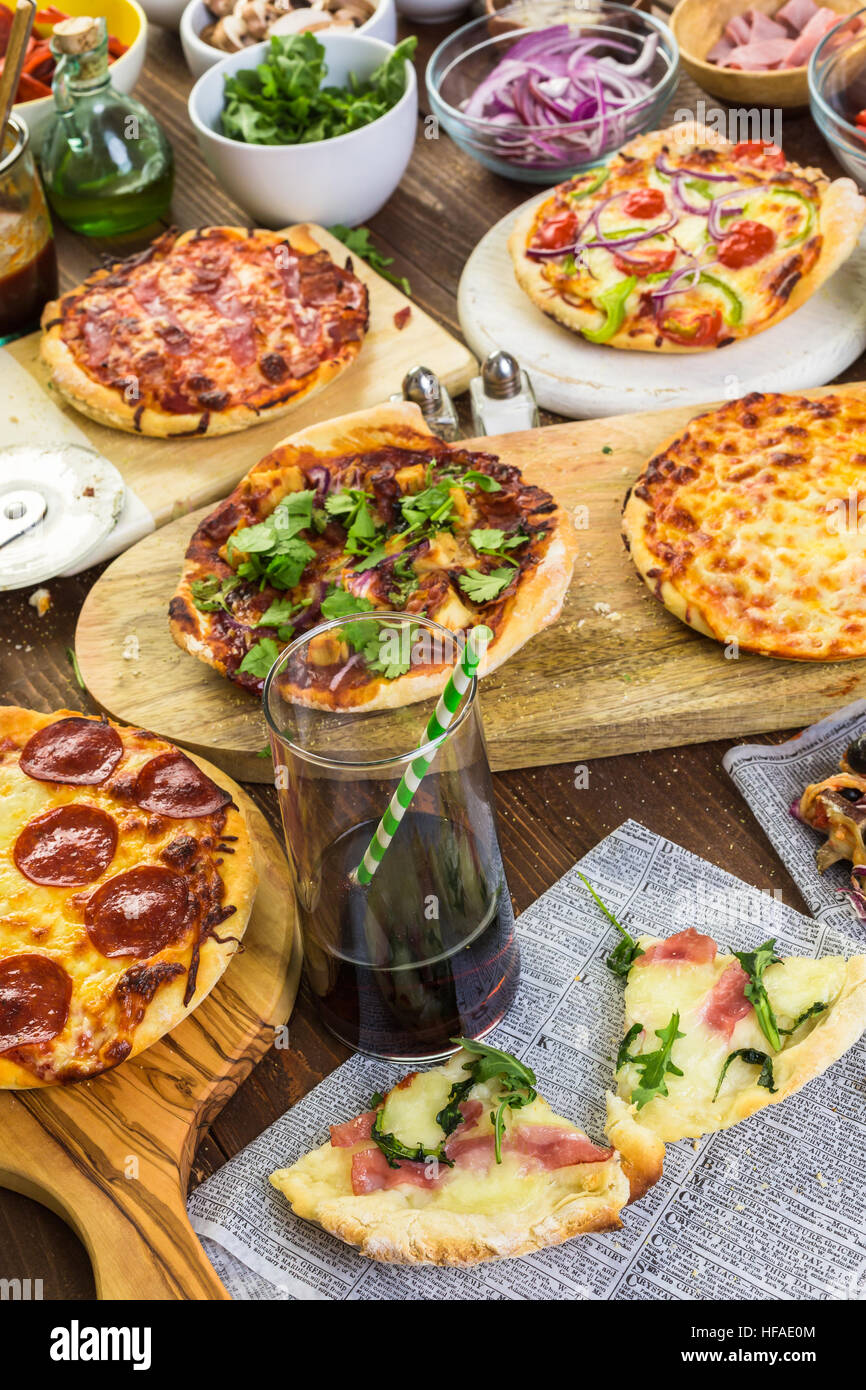 Eating individual pizzas from pizza bar Stock Photo - Alamy