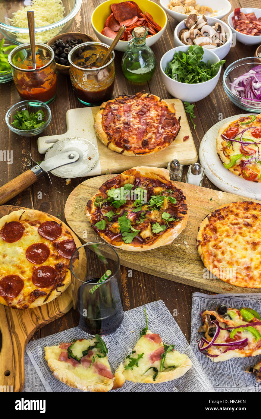 Eating individual pizzas from pizza bar Stock Photo - Alamy