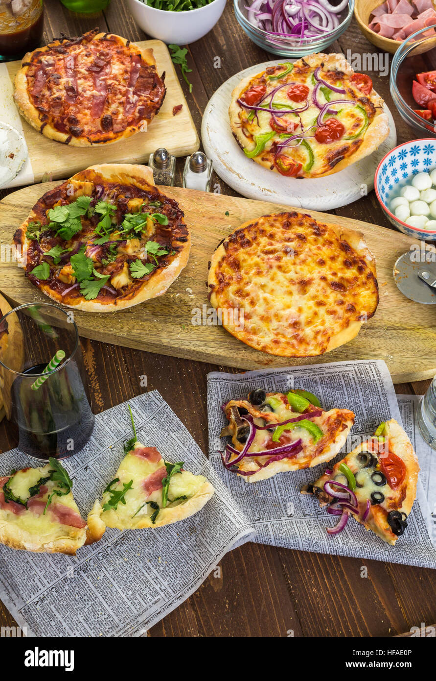 Eating individual pizzas from pizza bar Stock Photo - Alamy