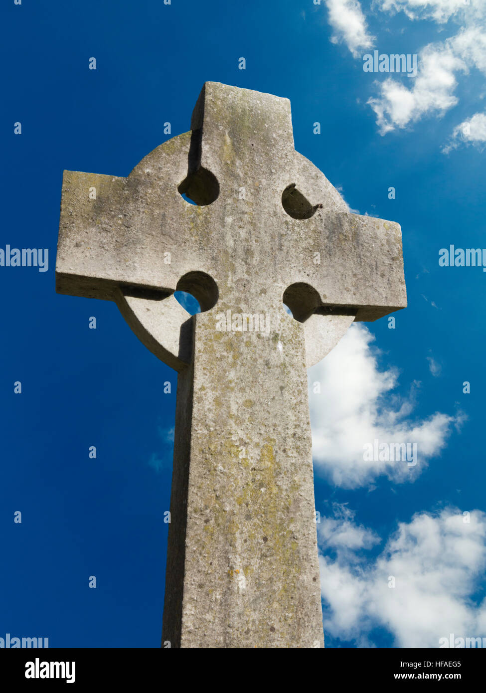 Plain Celtic cross headstone against a blue sky with light cloud Stock ...