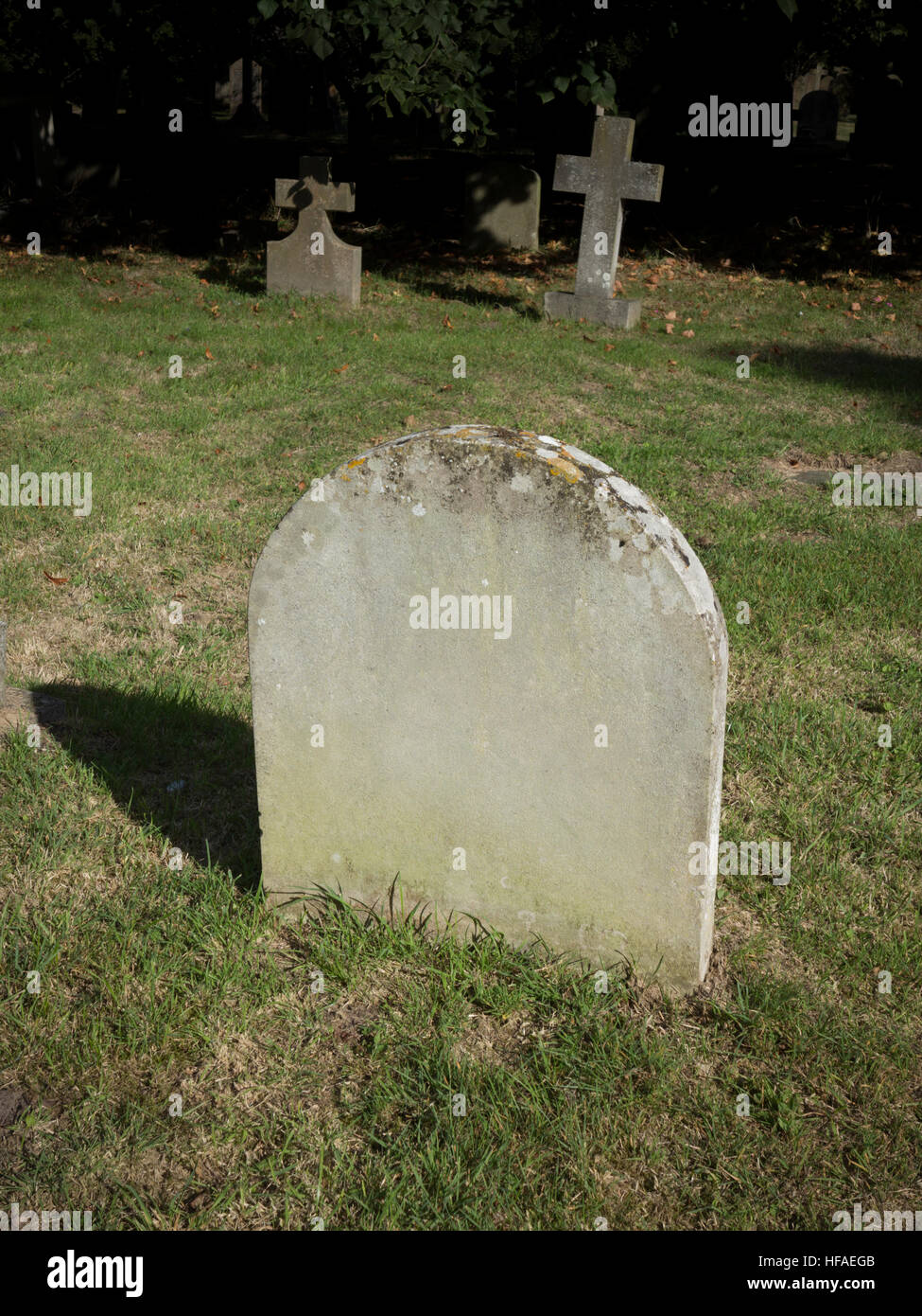 Plain slab headstone with rounded top with headstone crosses in the ...