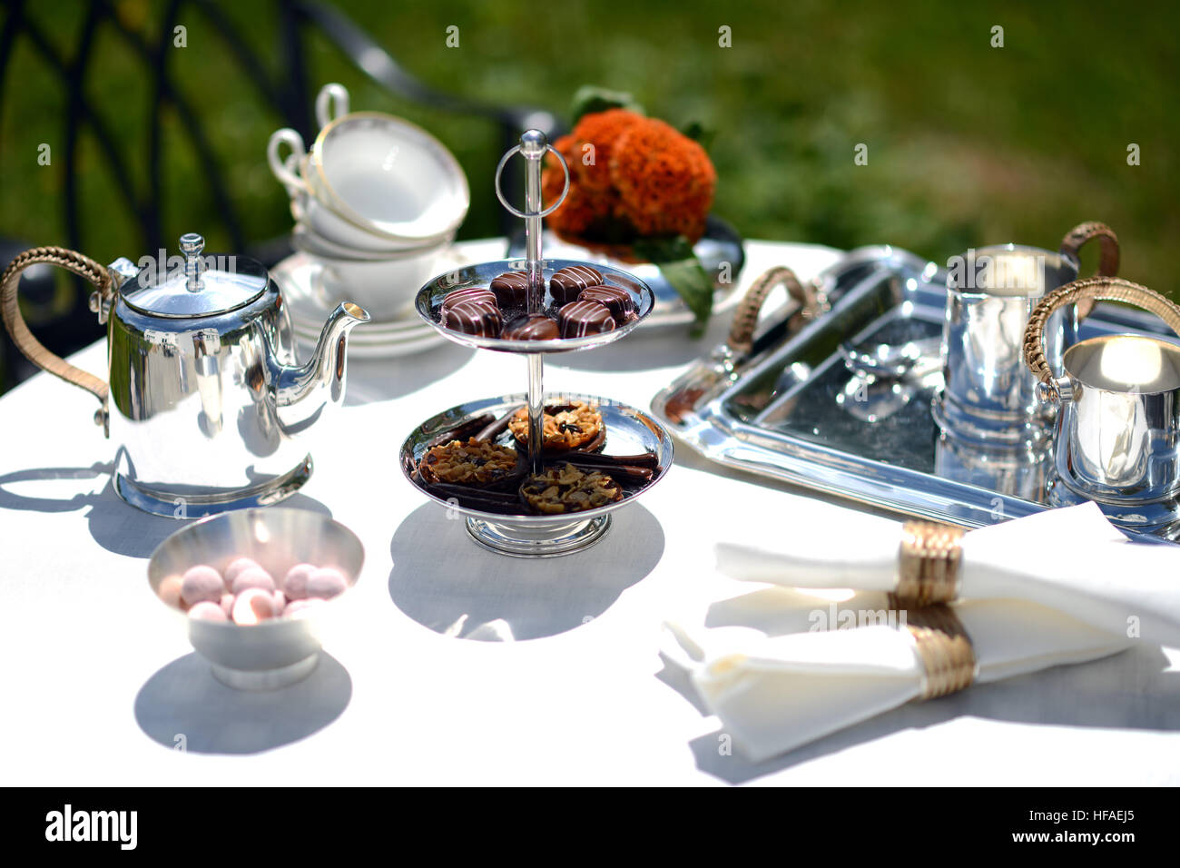 Table set for an English high tea, or afternoon tea, outside with ...