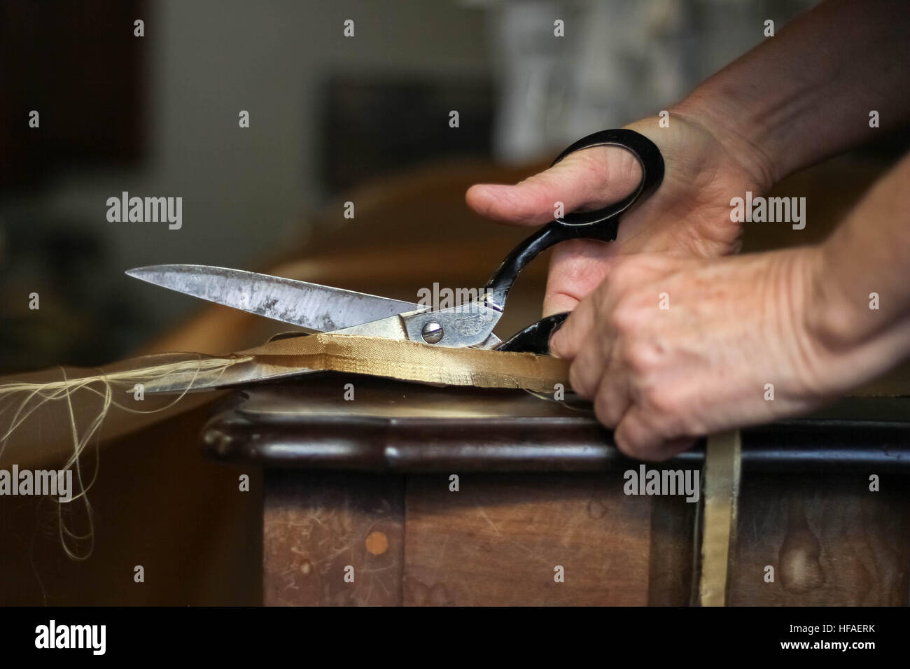 Woman cutting fabric with scissors Stock Photo - Alamy