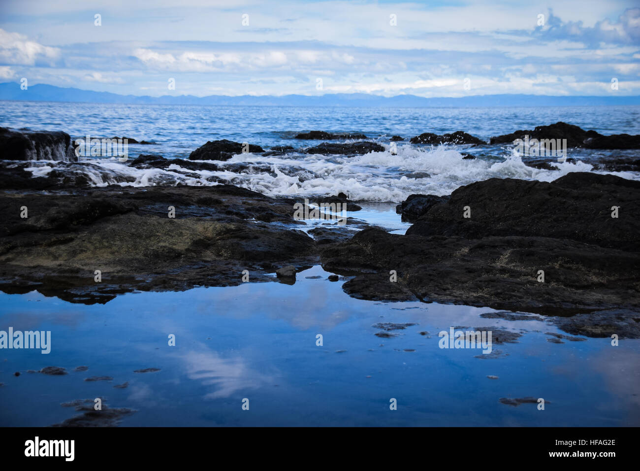 Rock pools reflecting blue sky hi-res stock photography and images - Alamy
