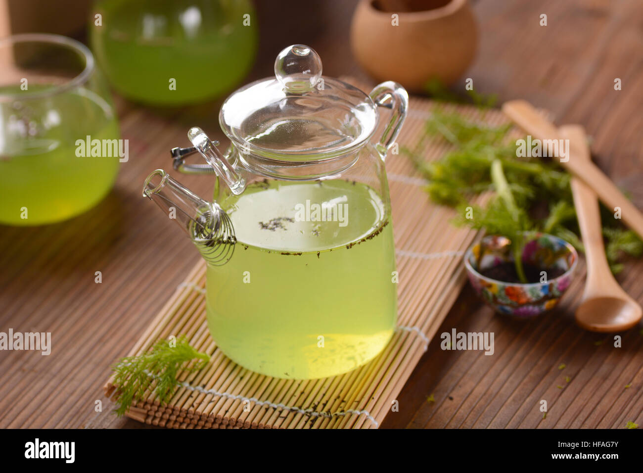 Green tea in glass teapot Stock Photo - Alamy