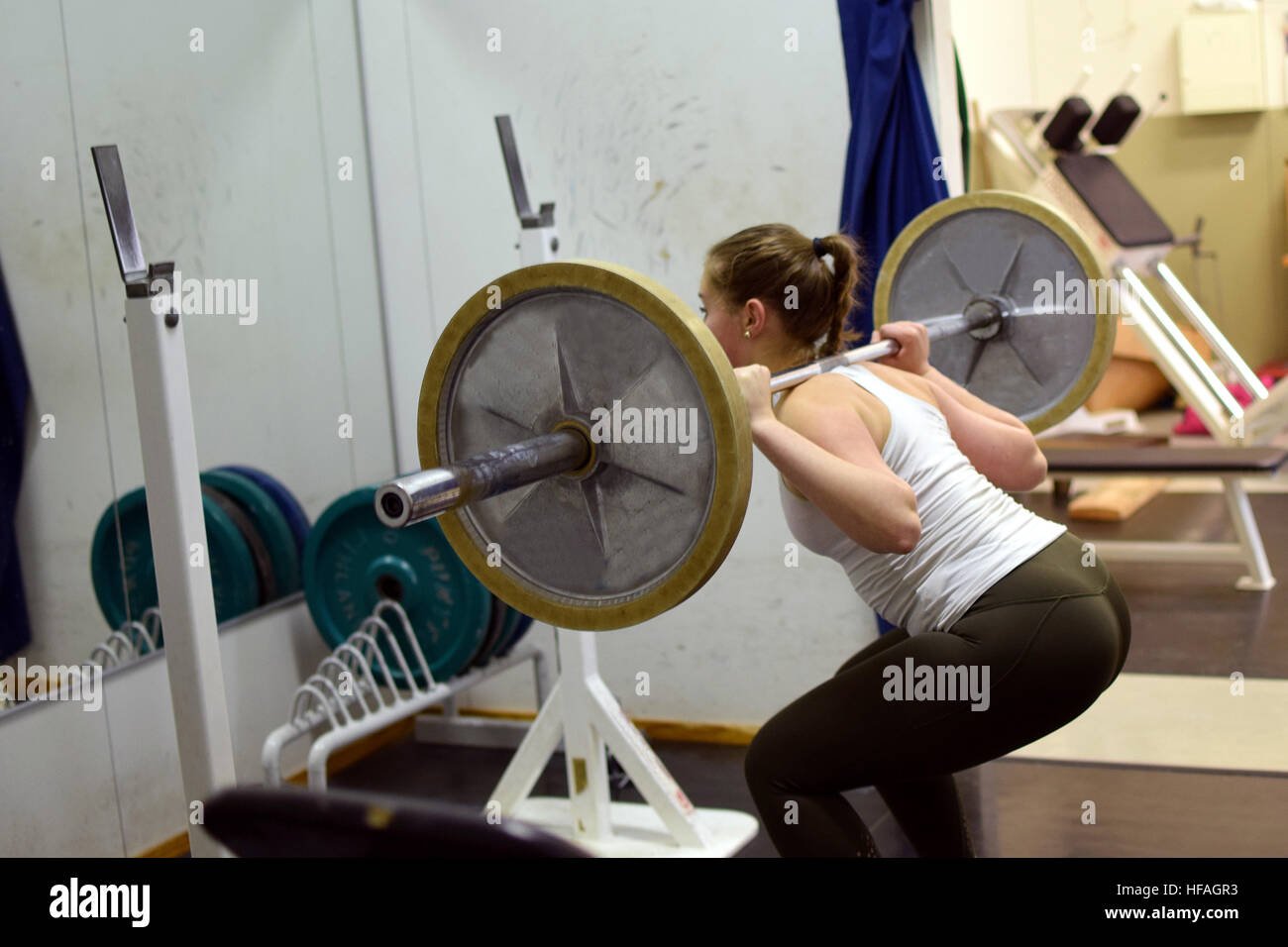 Woman at the gym. Barbell squat exercise Stock Photo - Alamy