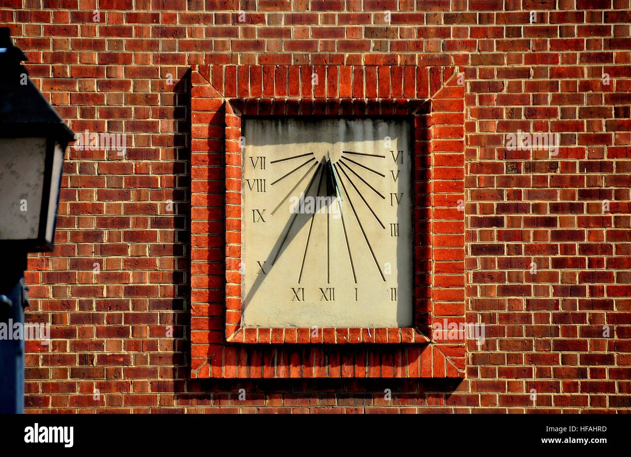 Alexandria, Virginia - April 13, 2014: Sundial clock on a brick wall at ...