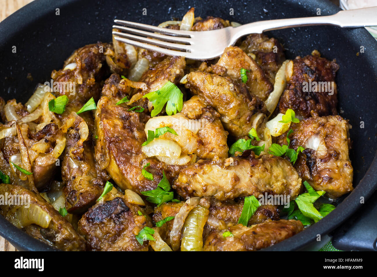 Fried beef liver with onions, curry and spices Stock Photo - Alamy