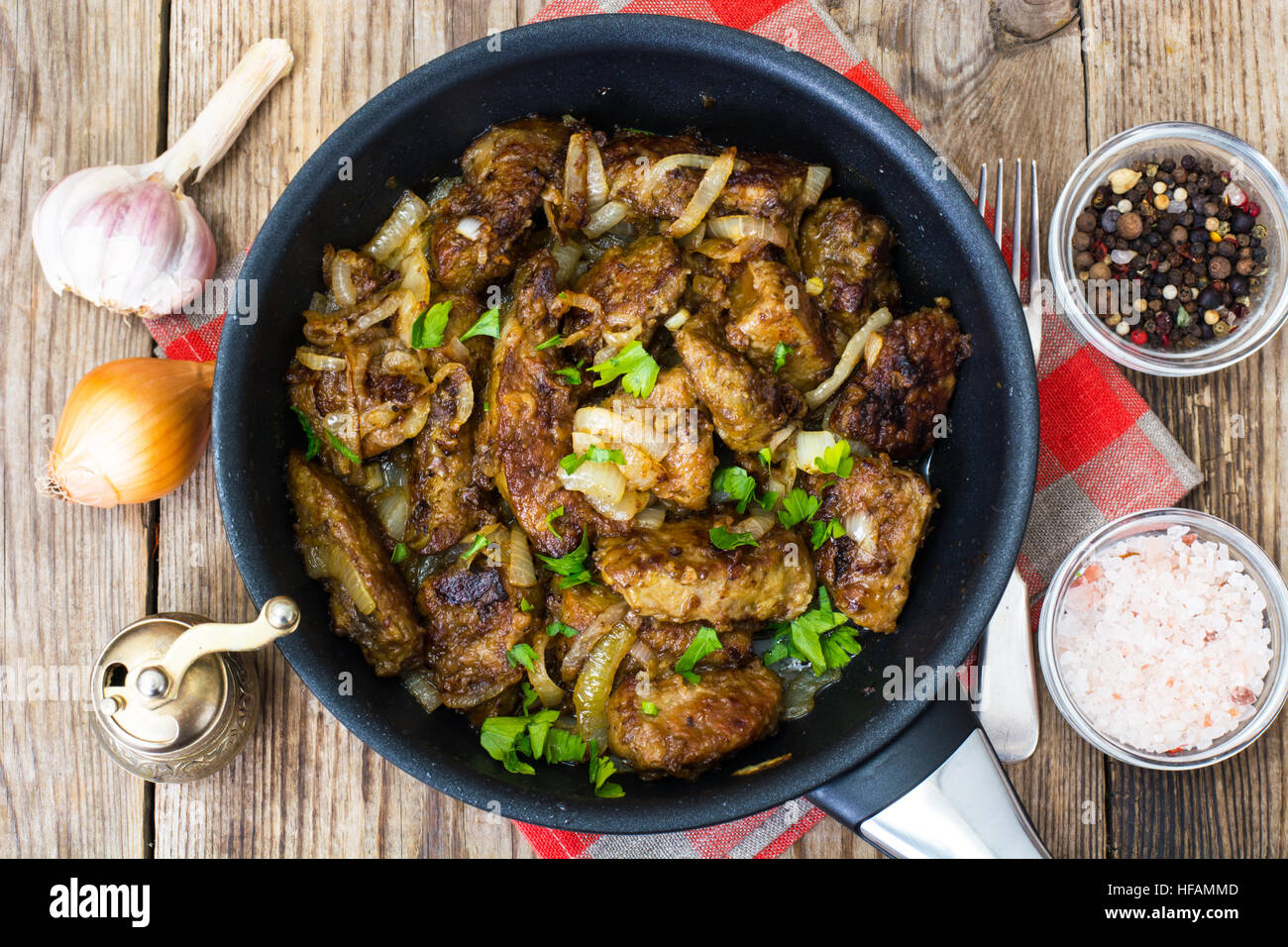 Fried beef liver with onions, curry and spices Stock Photo - Alamy