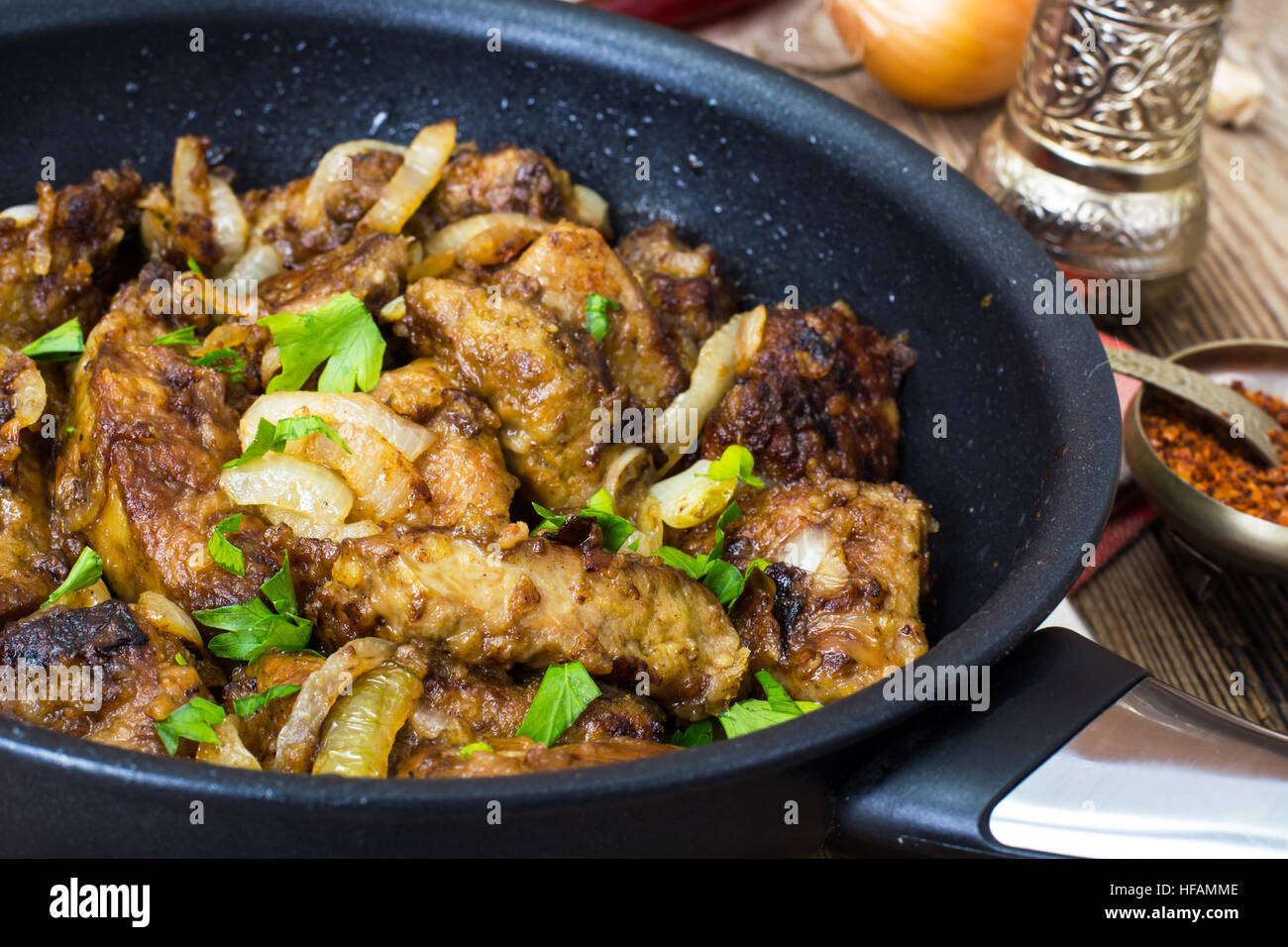 Fried beef liver with onions, curry and spices Stock Photo - Alamy