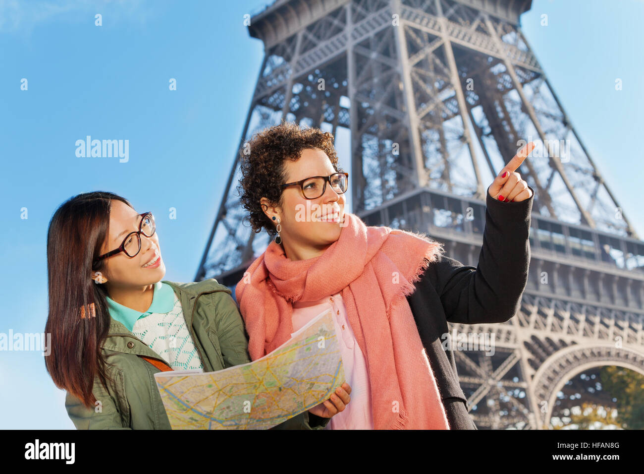 Two women searching right way travelling in Paris Stock Photo - Alamy