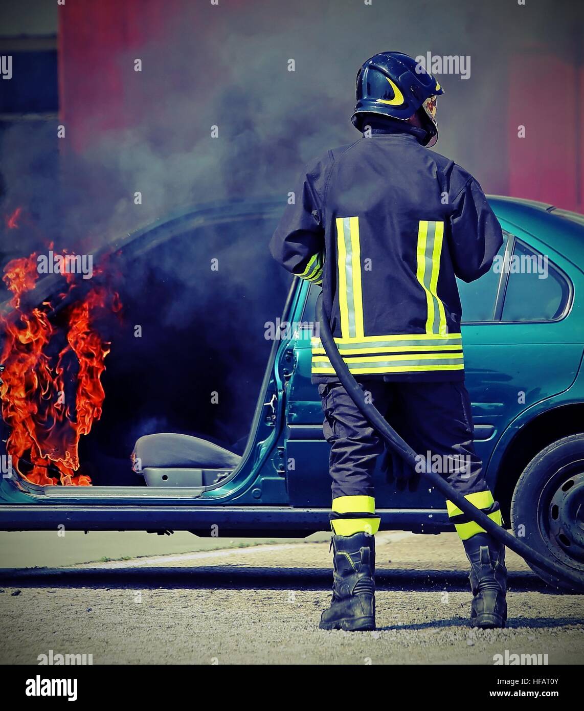 firefighter during shutdown of a fire of a car after car accident Stock ...