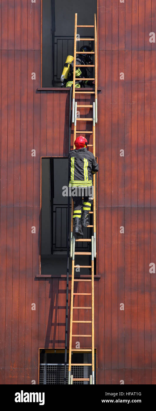 Fireman up ladder hi-res stock photography and images - Alamy