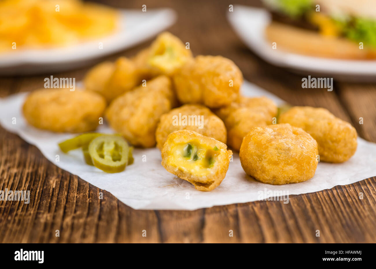Cheese Nuggets as high detailed close-up shot on a vintage wooden table ...