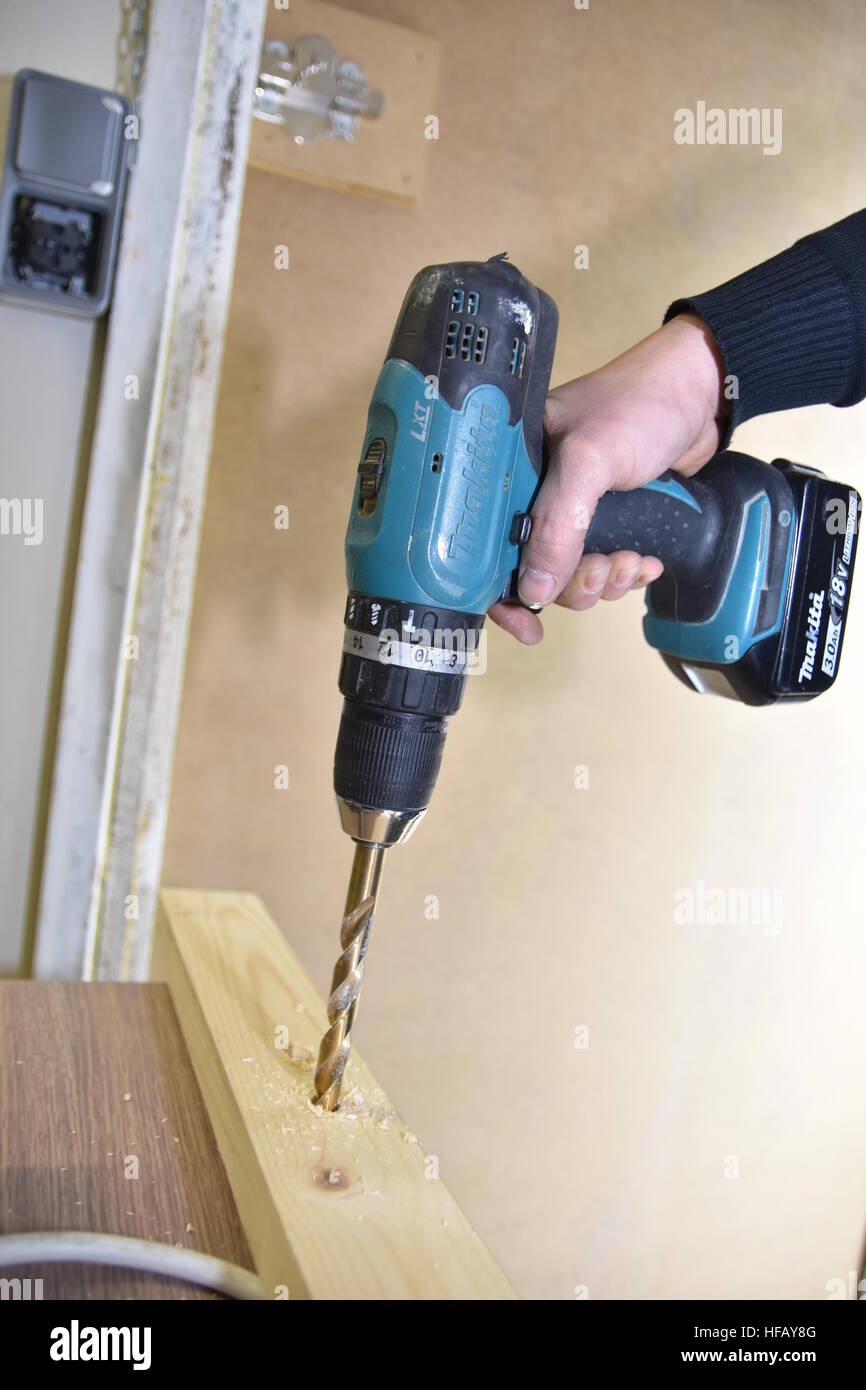 Carpenter working with wooden drill on a table Stock Photo - Alamy
