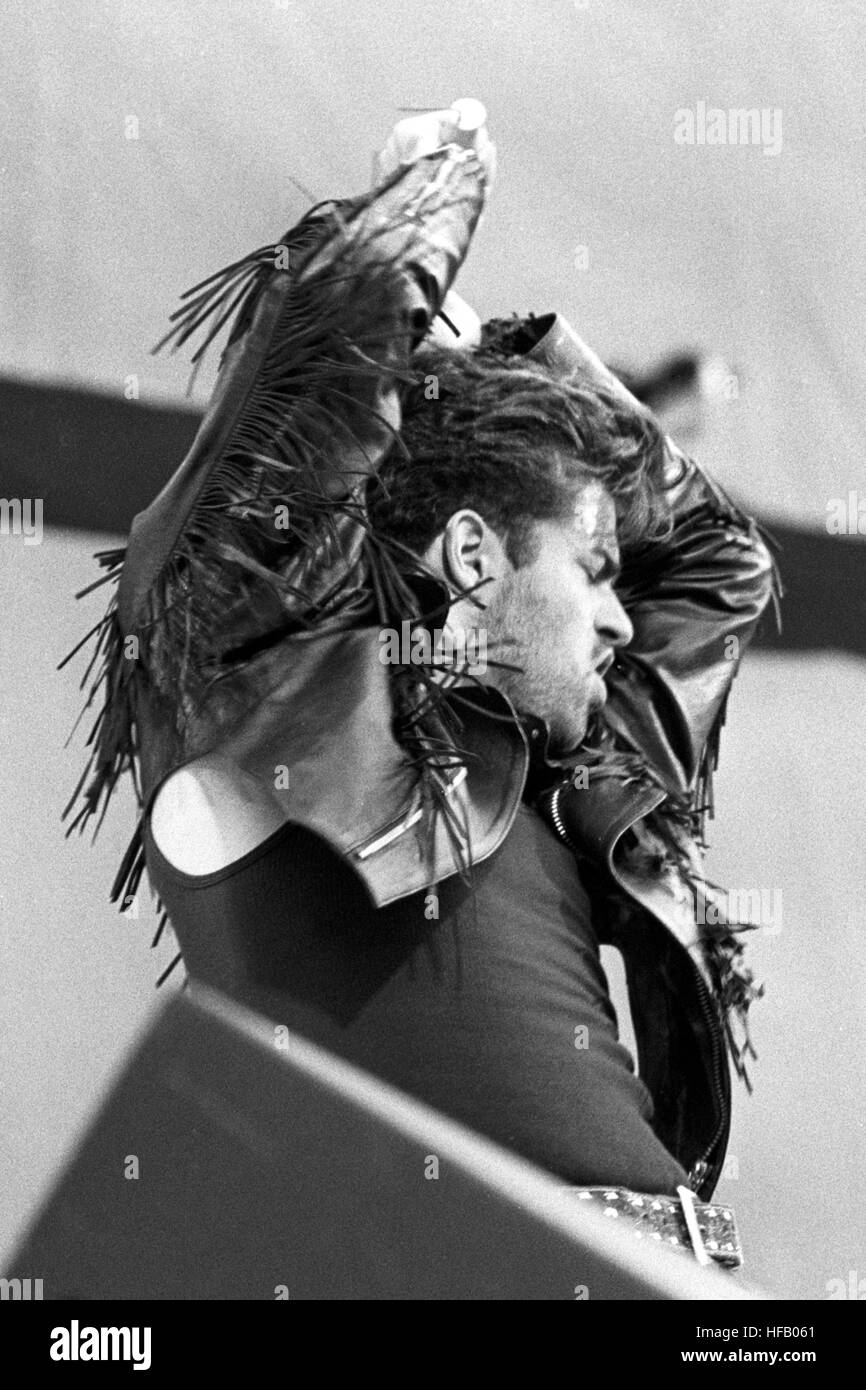 George Michael dances on stage at Wembley Stadium for the Wham! sell ...