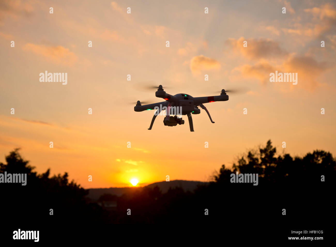Drone hovering at sunset Stock Photo - Alamy