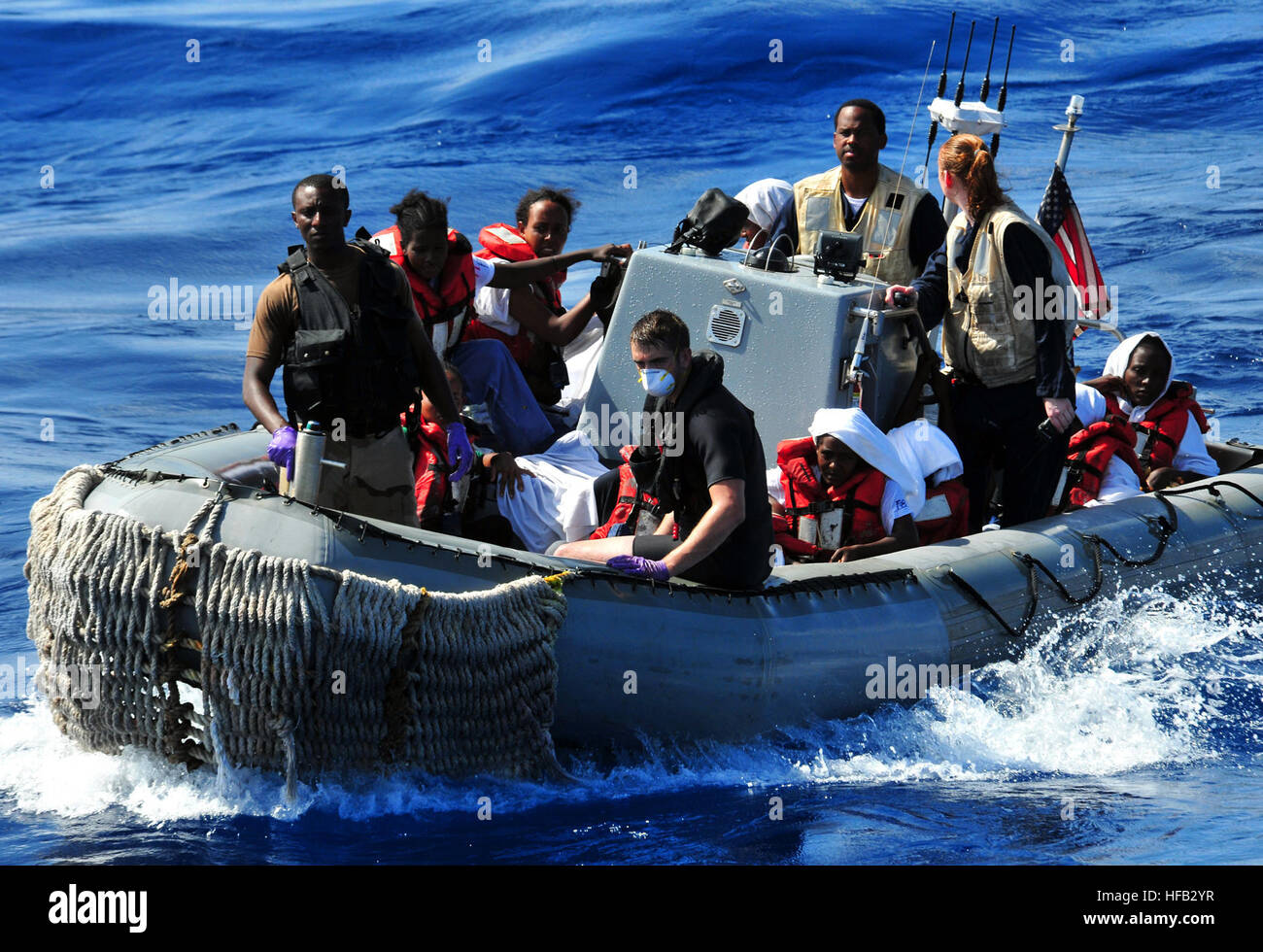Rescued persons ride in a U.S. Navy rigid hull inflatable boat to ...